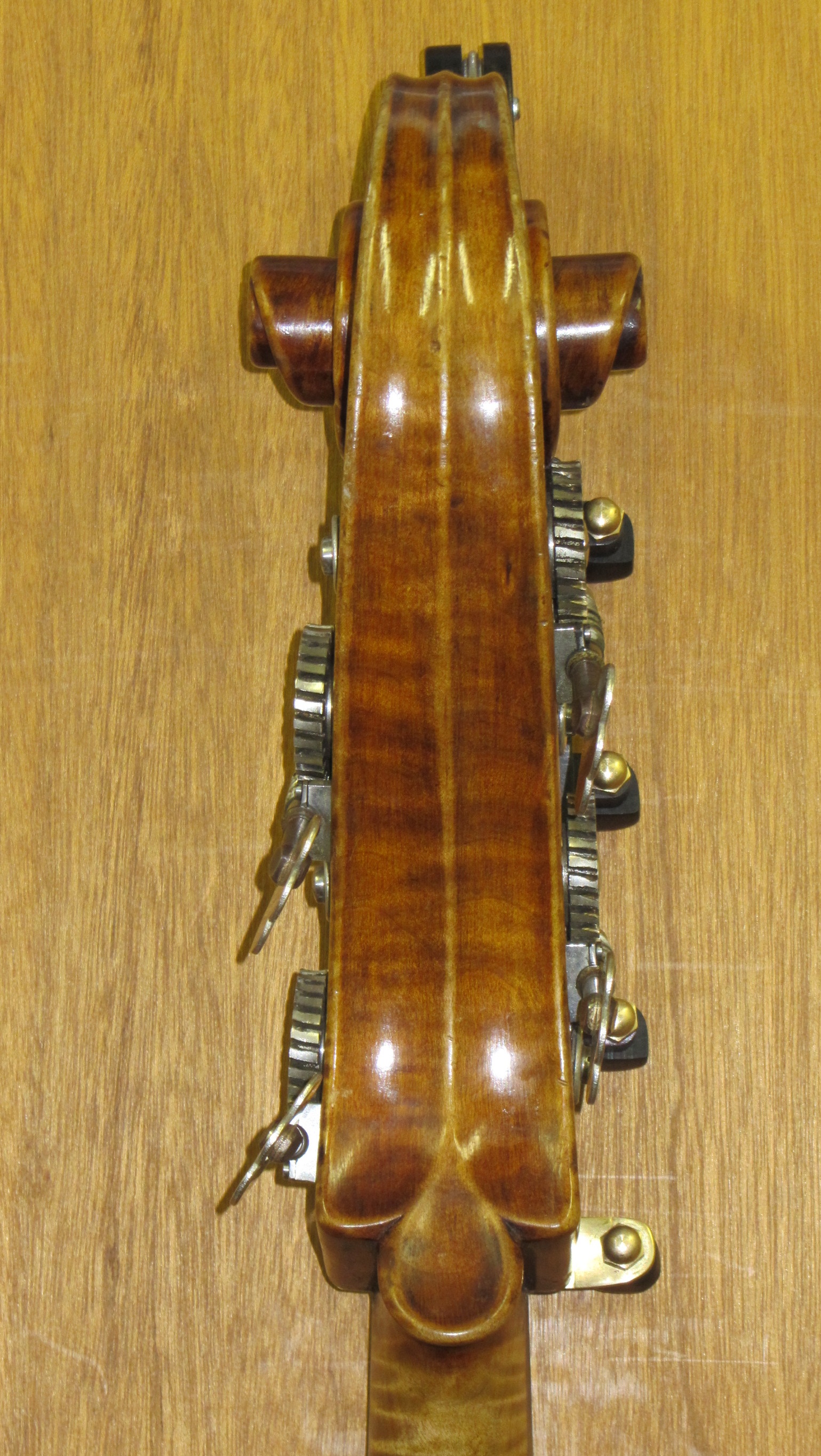 Hand Carved Plate design around the Tuners on the Scroll Cheeks