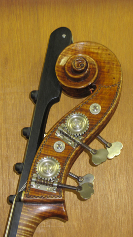 Hand Carved Plate design around the Tuners on the Scroll Cheeks